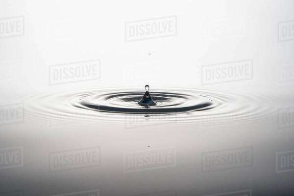 Water droplet falling into water - Royalty-free Stock Photo | Dissolve