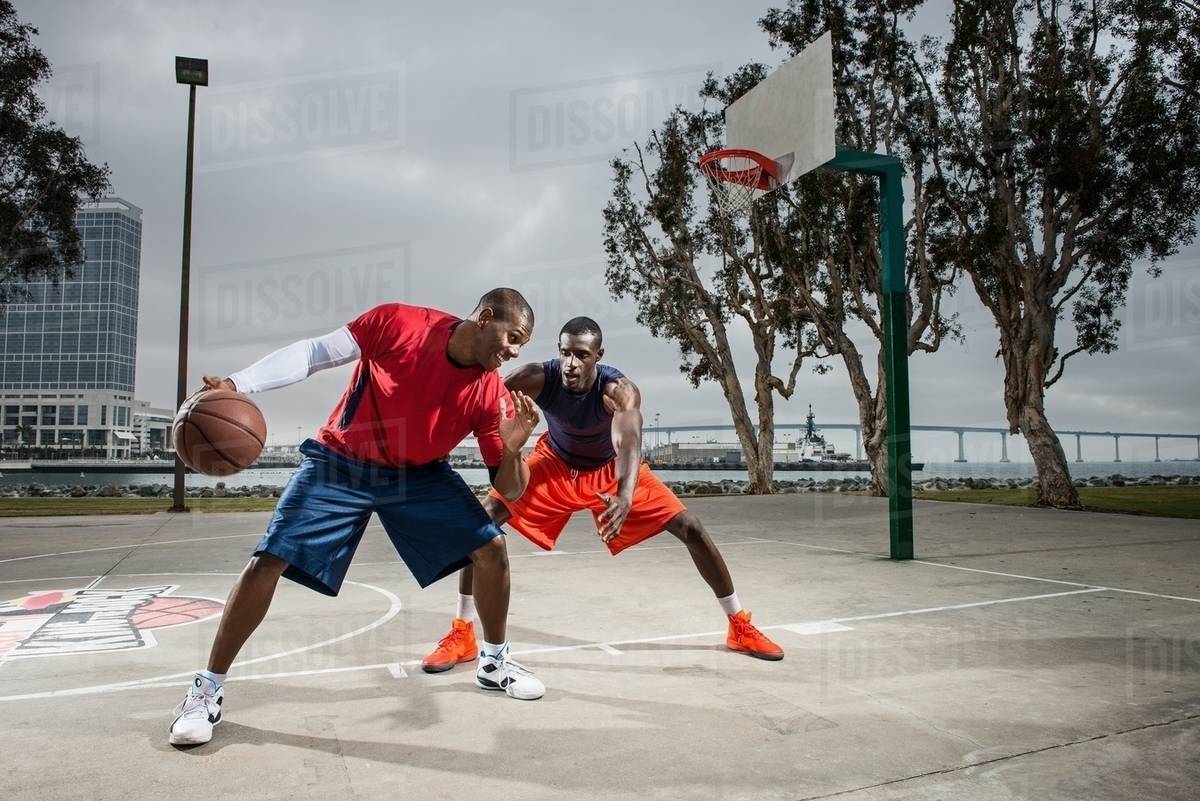 Young basketball players playing on court - Stock Photo - Dissolve