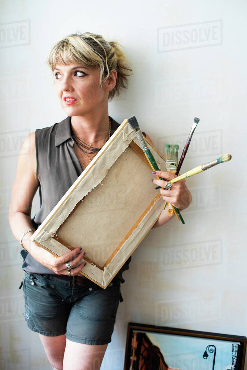 Portrait of fine art painter with painting and paint brushes - Royalty ...