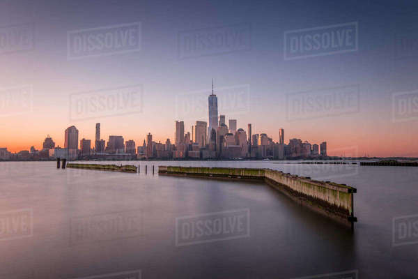 View across the water of New York City, Manhattan island, at dawn, flat ...