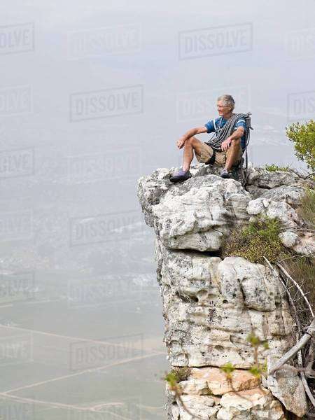 Man sitting on a rock - Royalty-free Stock Photo | Dissolve