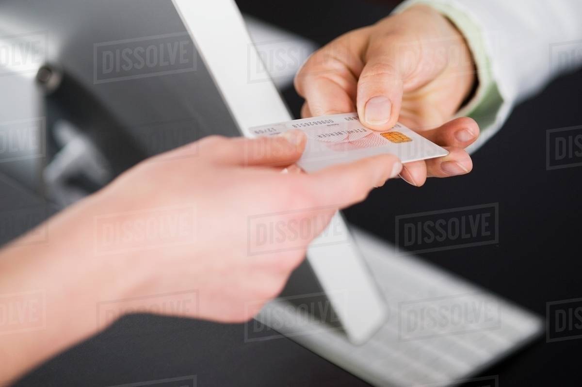 Handing over credit card - Royalty-free Stock Photo | Dissolve