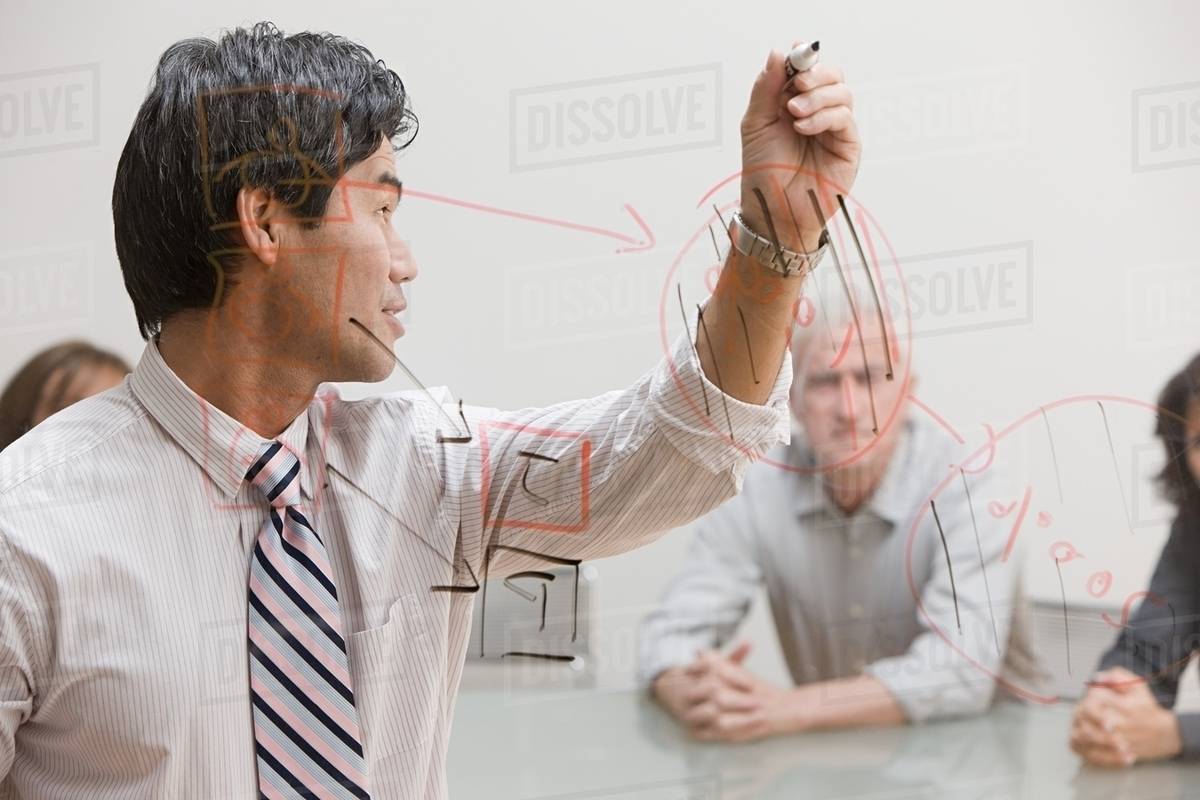 Man drawing diagram on glass - Royalty-free Stock Photo | Dissolve