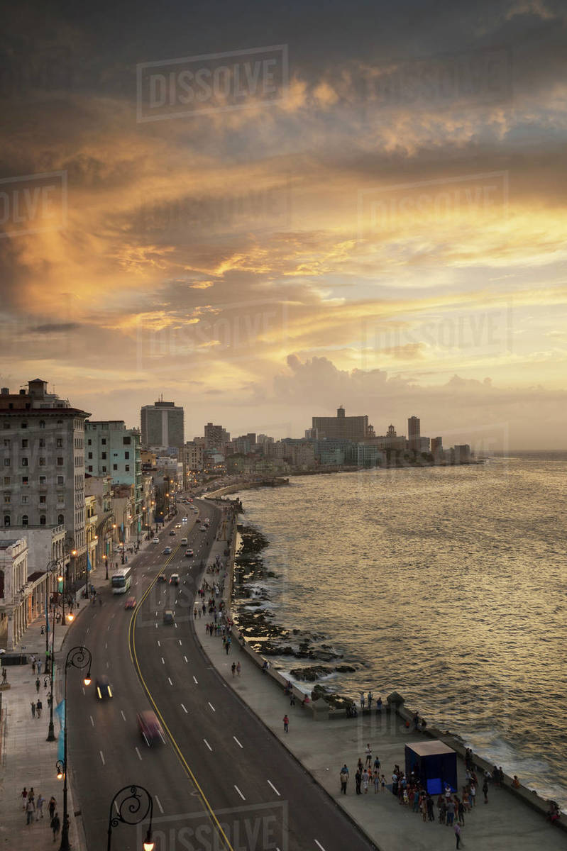 High angle view of waterfront traffic on El Malecon at dusk, Havana ...