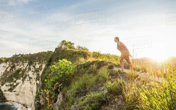Tourist wandering on cliff, Nusa Penida, Bali, Indonesia - Royalty-free ...