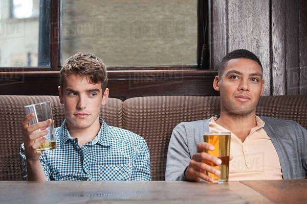 Two young men in bar - Royalty-free Stock Photo | Dissolve