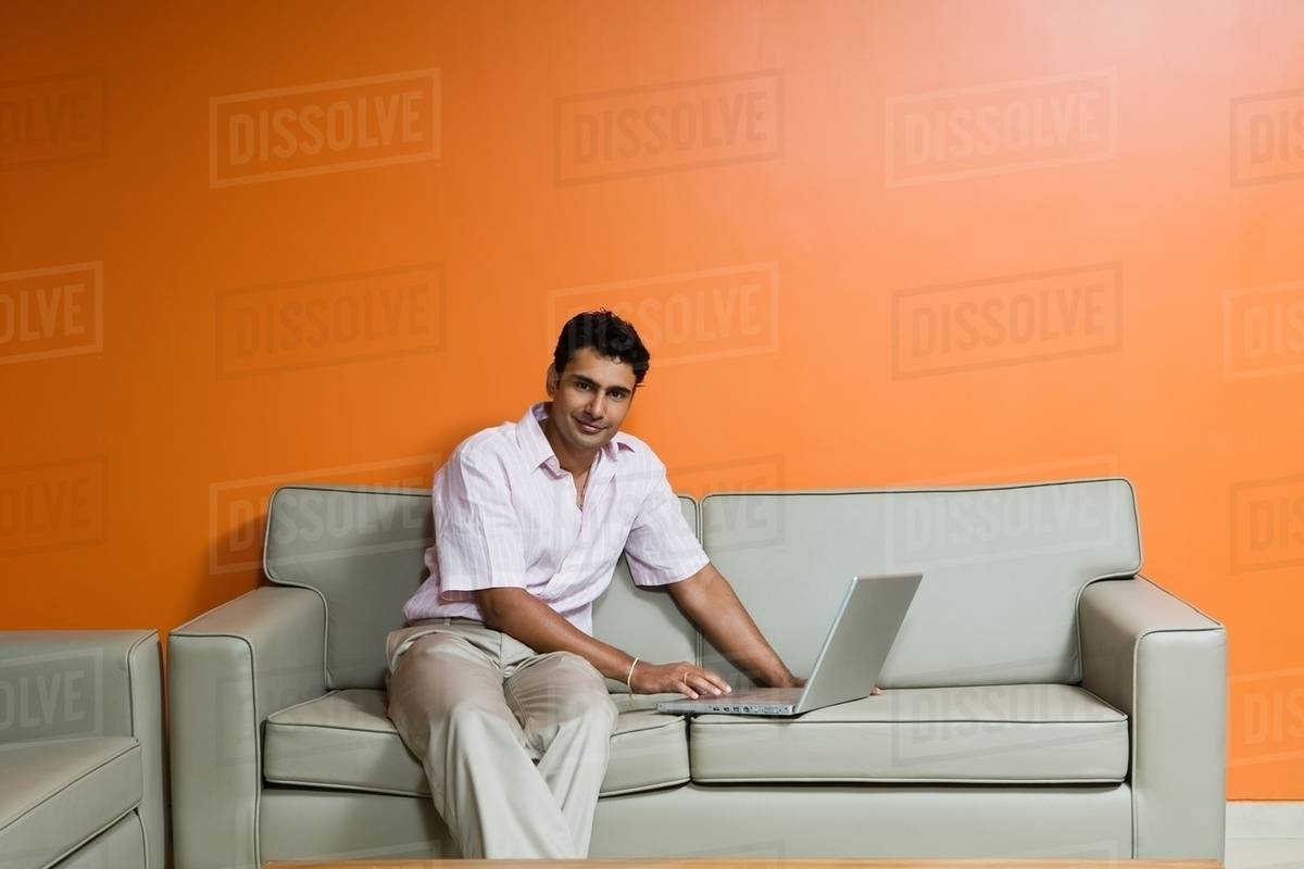 Indian man using a laptop computer - Royalty-free Stock Photo | Dissolve