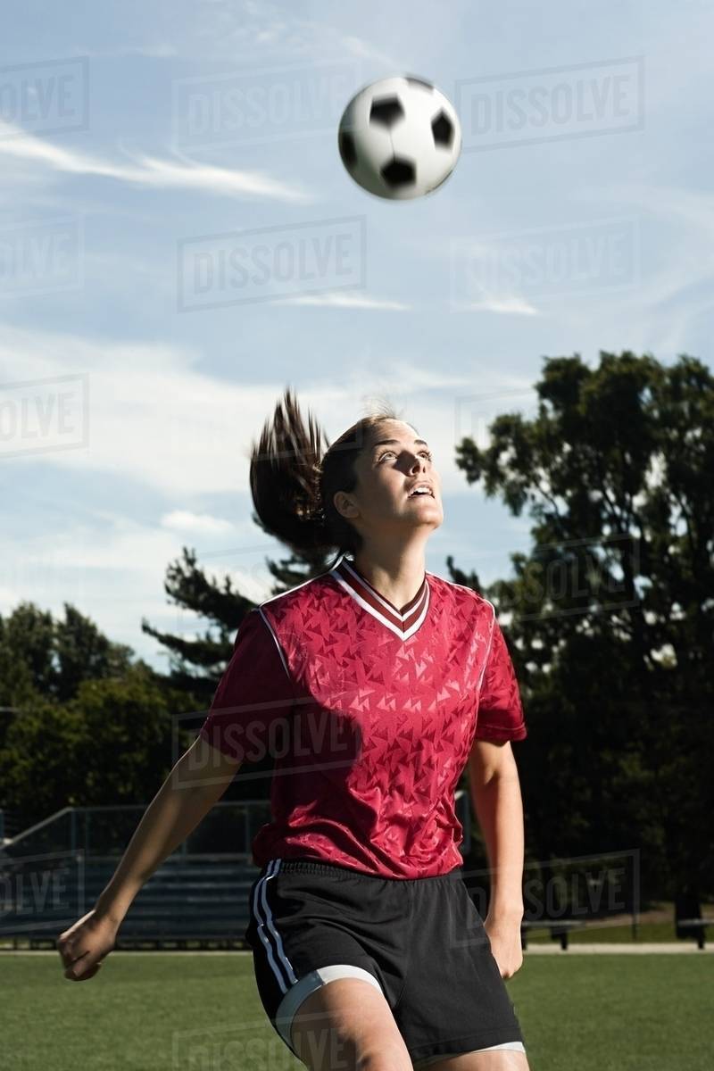 Footballer heading the ball - Stock Photo - Dissolve