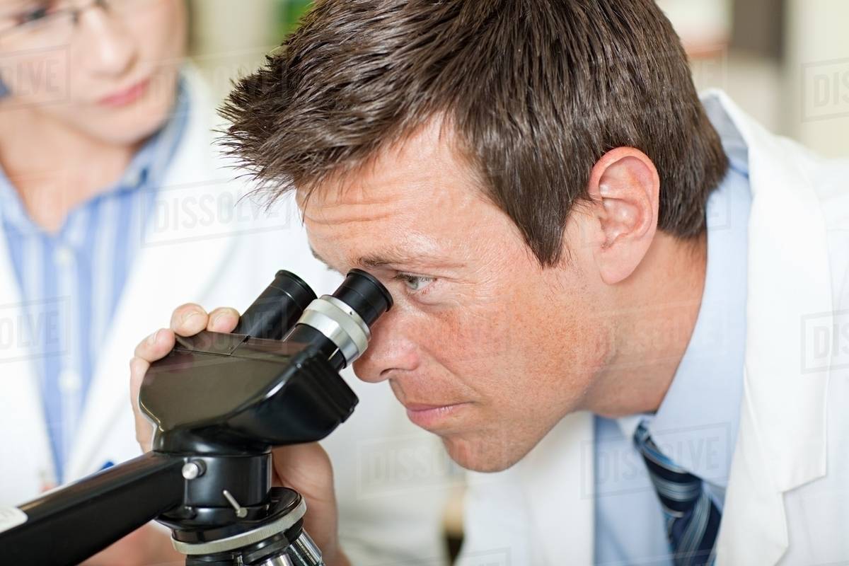 Doctors with microscope - Royalty-free Stock Photo | Dissolve