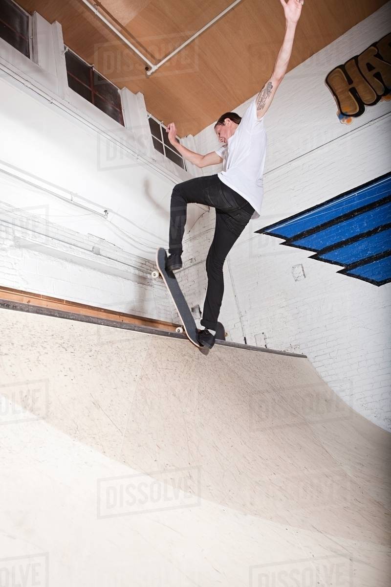 Skateboarder on ramp at skate park - Royalty-free Stock Photo | Dissolve