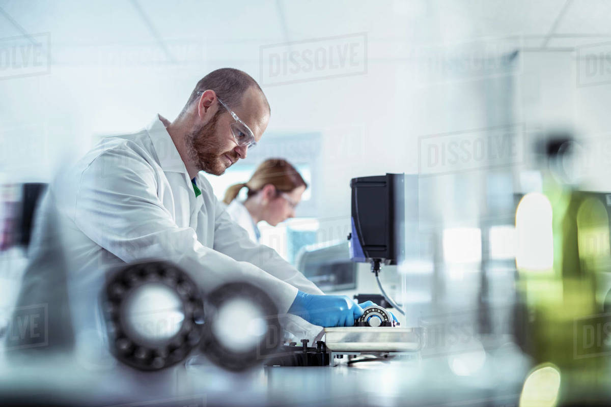 Laboratory workers testing bearing lubricant - Stock Photo - Dissolve