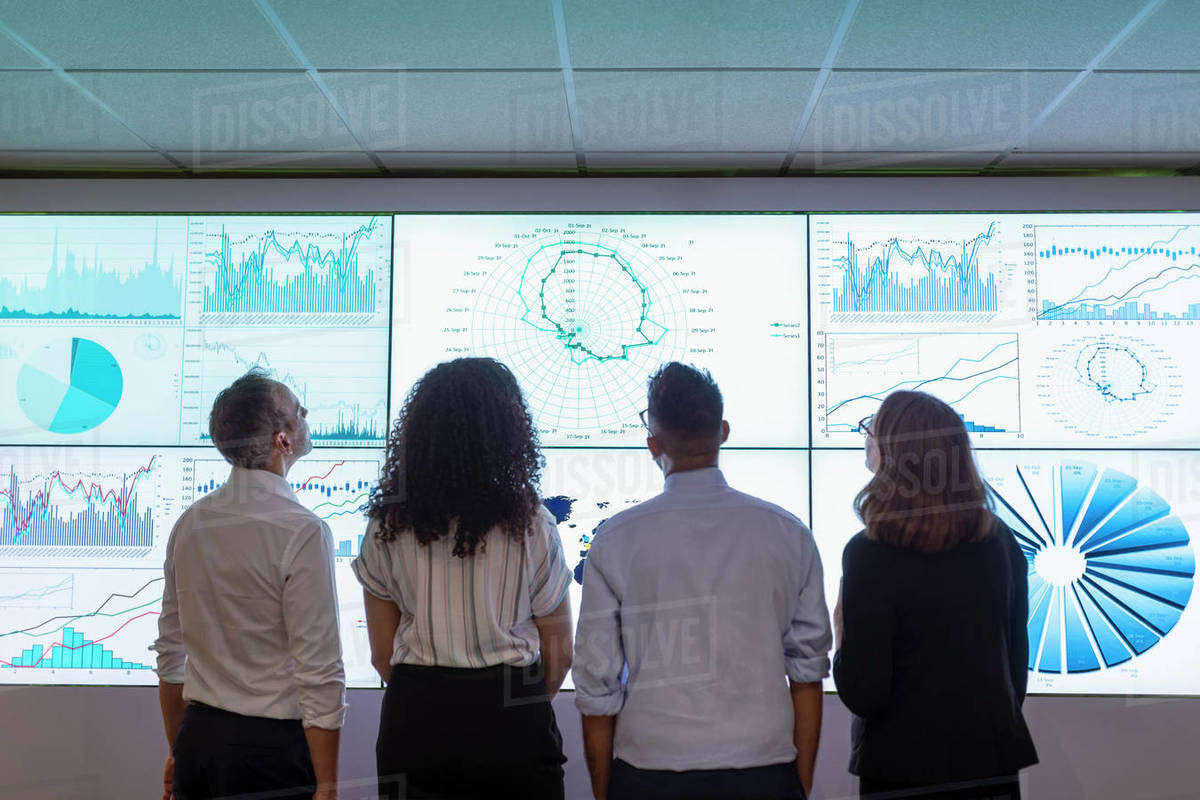 Business people looking at charts on interactive screens - Stock Photo ...