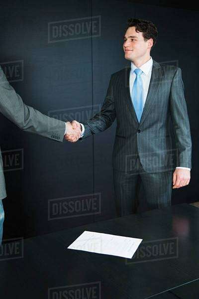 Two businessmen shaking hands at job interview - Royalty-free Stock ...