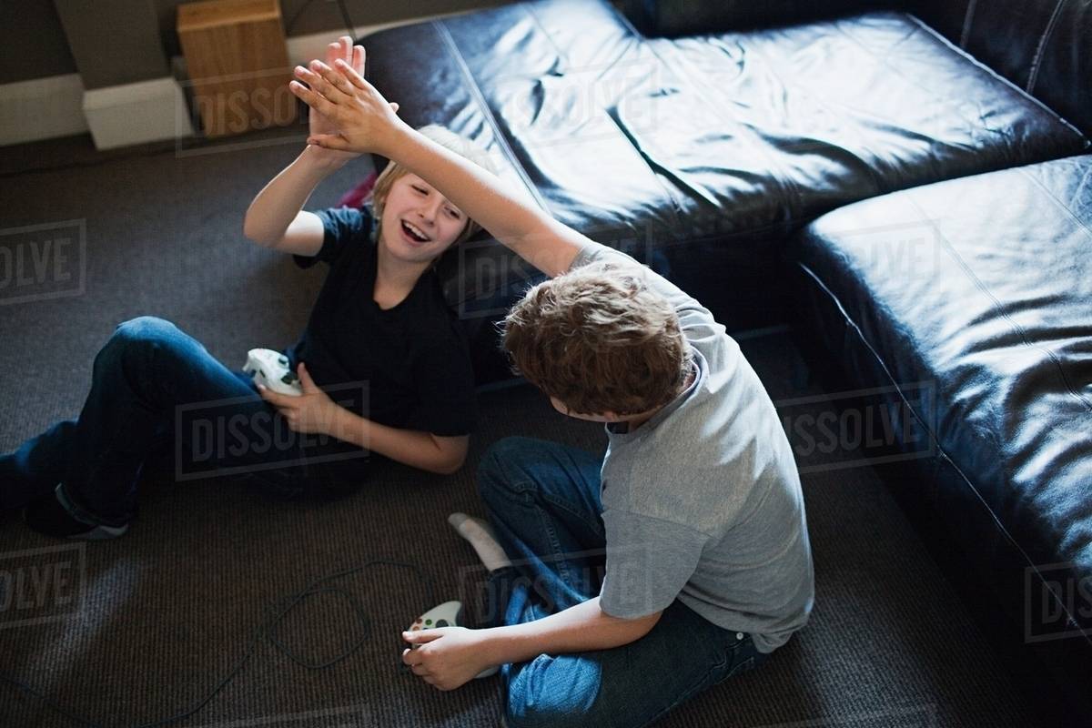 Two boys playing video games - Royalty-free Stock Photo | Dissolve