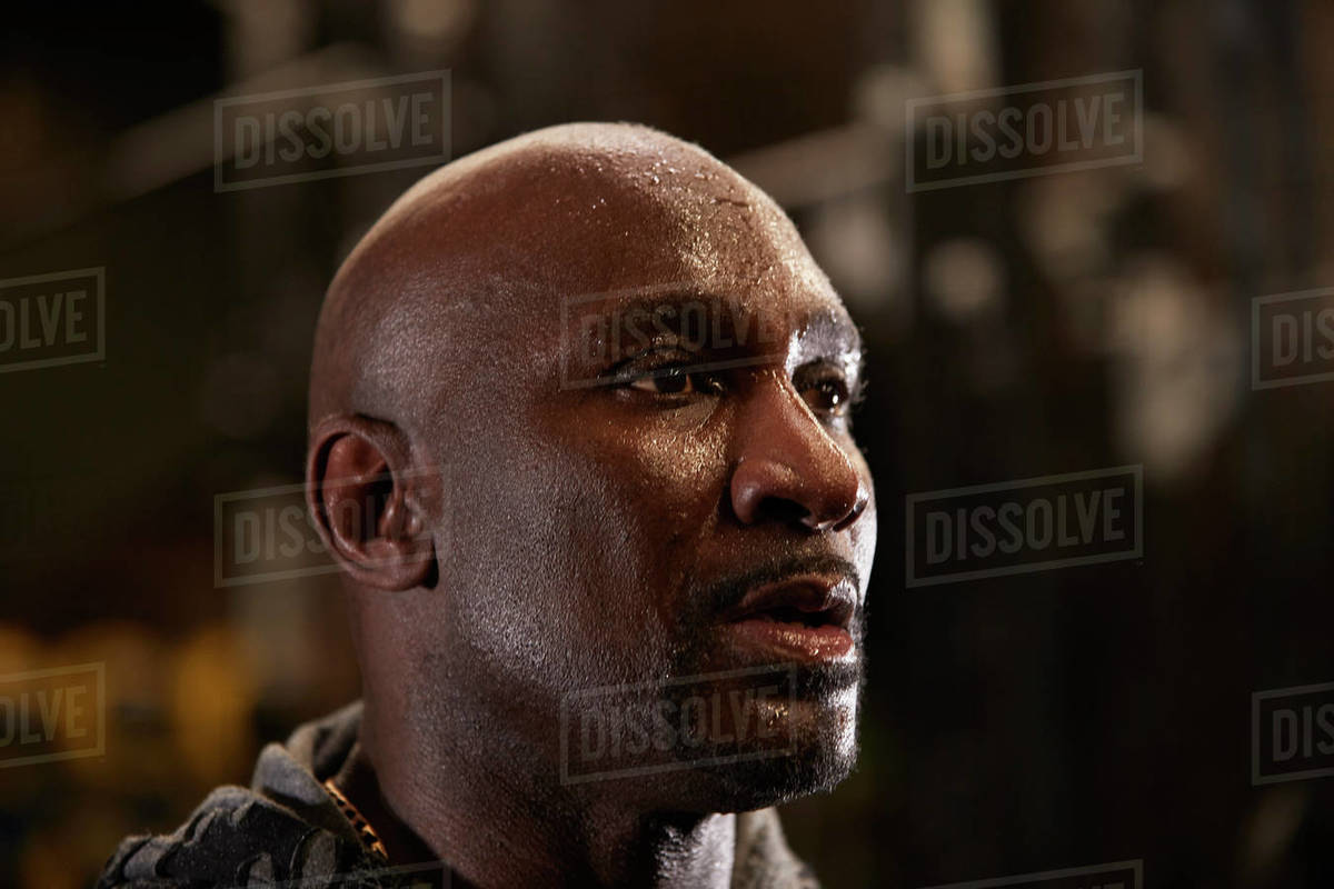 Close-up of man with sweat on face in gym - Stock Photo - Dissolve