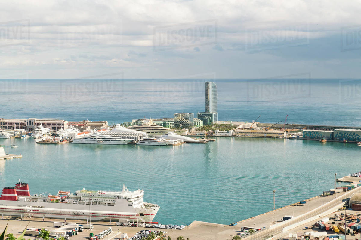 Spain, Catalonia, Barcelona, Ships in port and sea - Stock Photo - Dissolve