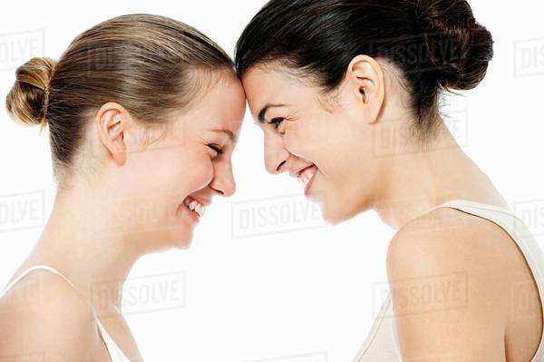 Two young women face to face - Royalty-free Stock Photo | Dissolve