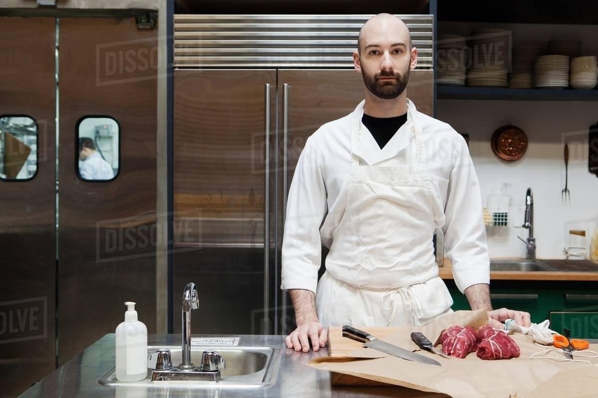 Butcher preparing beef tenderloin - Royalty-free Stock Photo | Dissolve