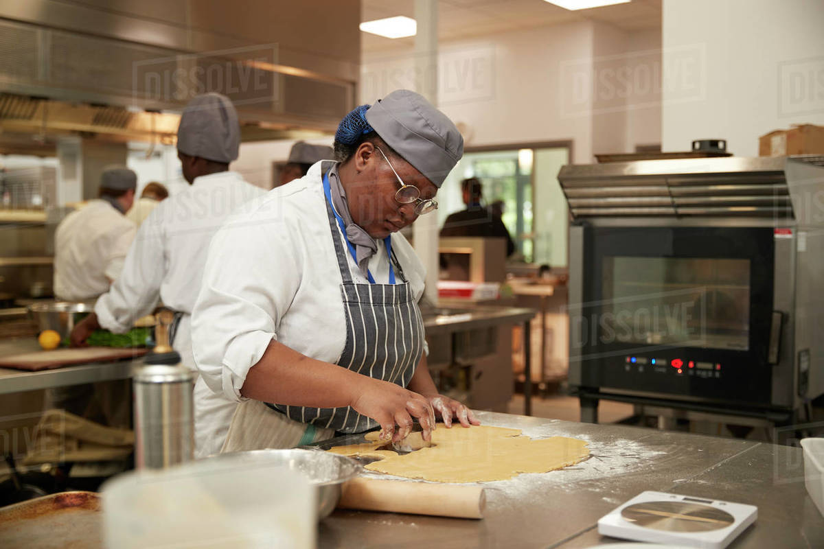 Female cook (16-17) working in kitchen - Royalty-free Stock Photo ...