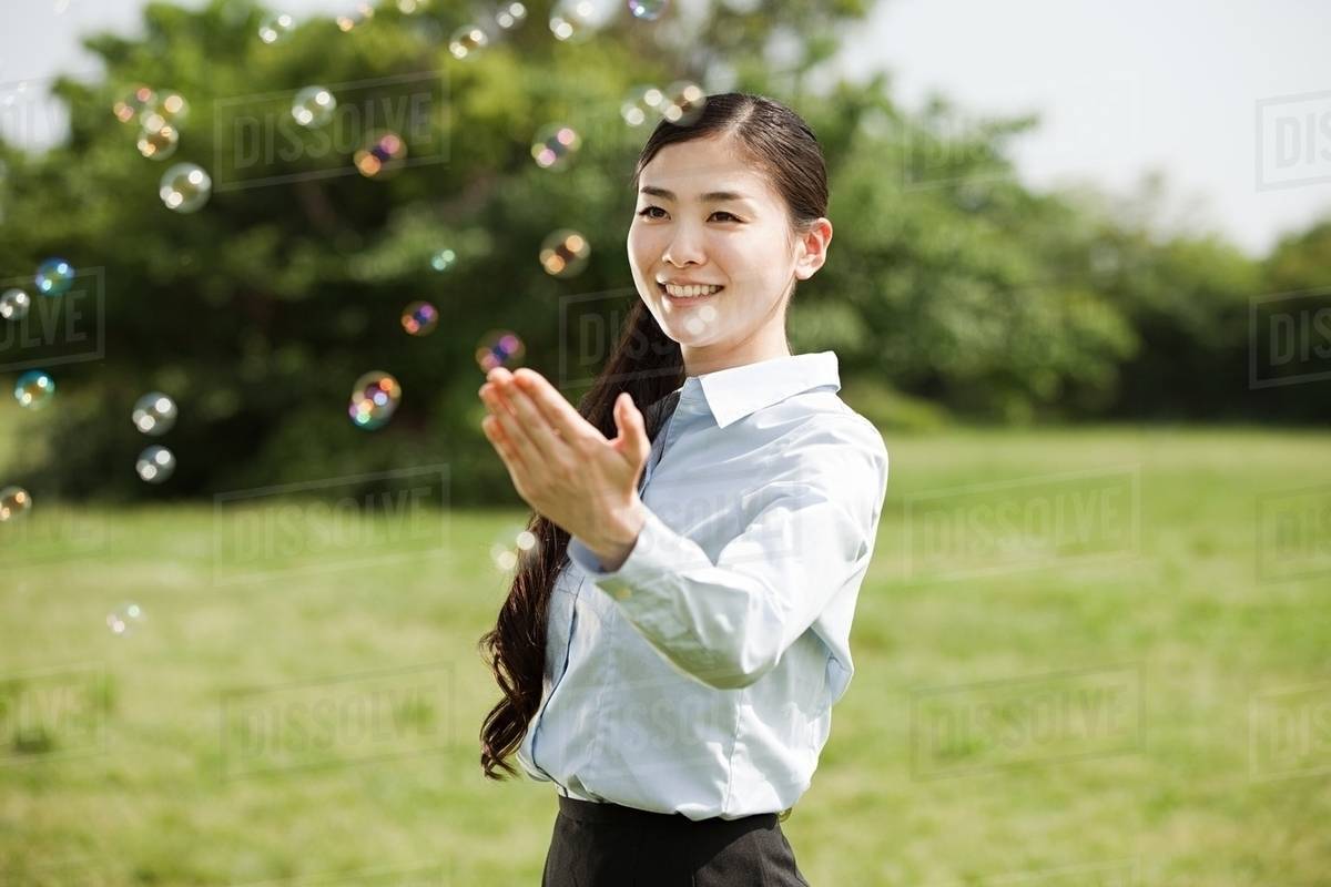 Portrait of young businesswoman touching bubbles - Royalty-free Stock ...