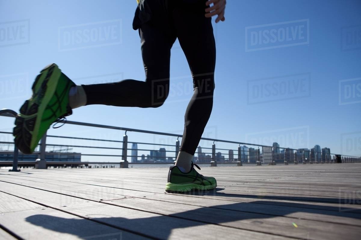 View of an athlete's legs running across walkway - Royalty-free Stock ...