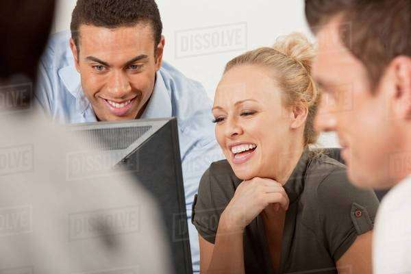 Colleagues looking at a computer screen together - Royalty-free Stock ...