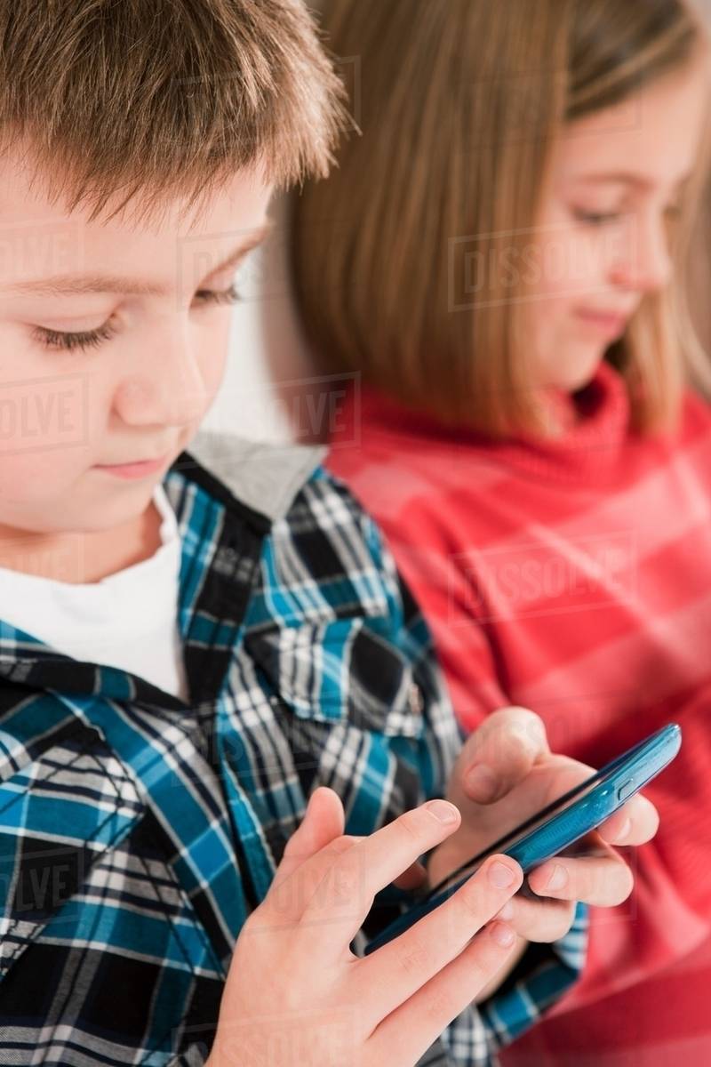 Children using smartphones - Stock Photo - Dissolve