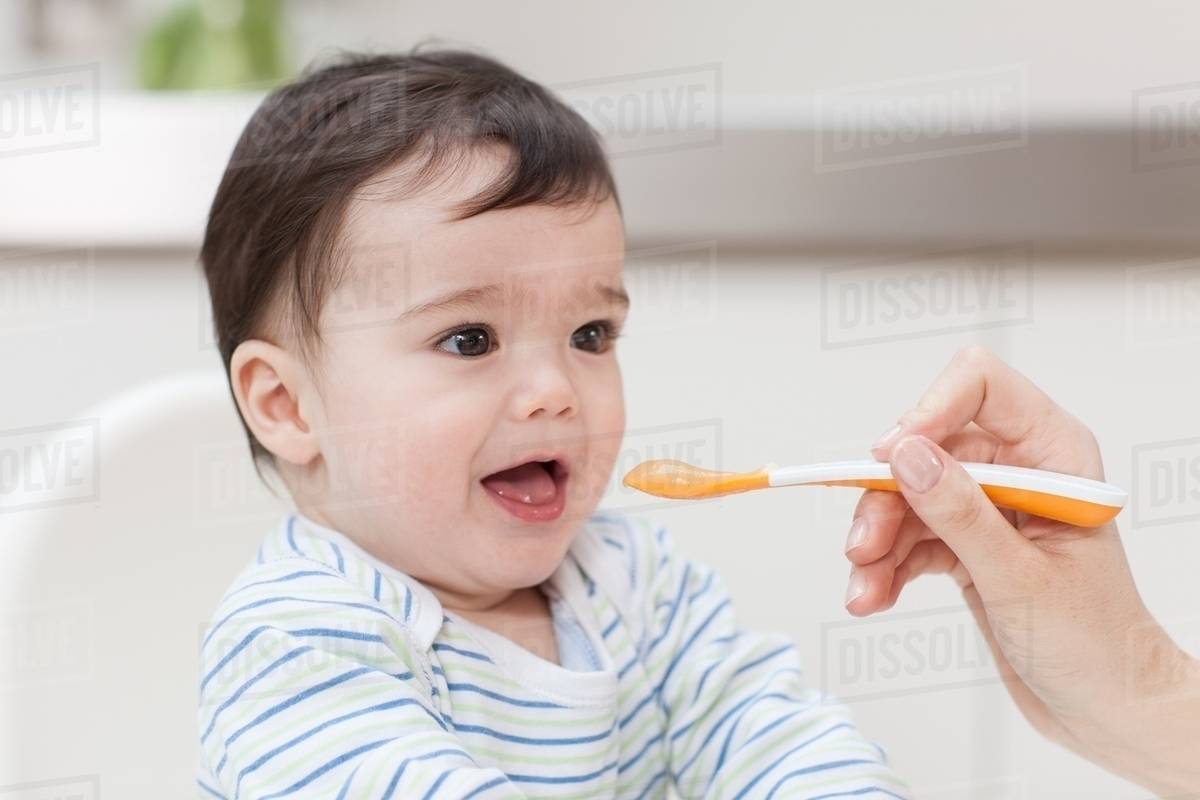 Baby boy being fed - Royalty-free Stock Photo | Dissolve
