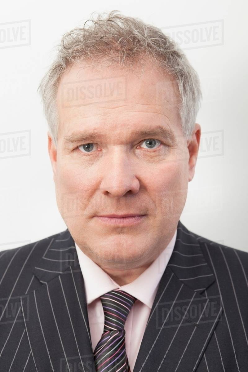 Businessman with serious expression, portrait - Stock Photo - Dissolve