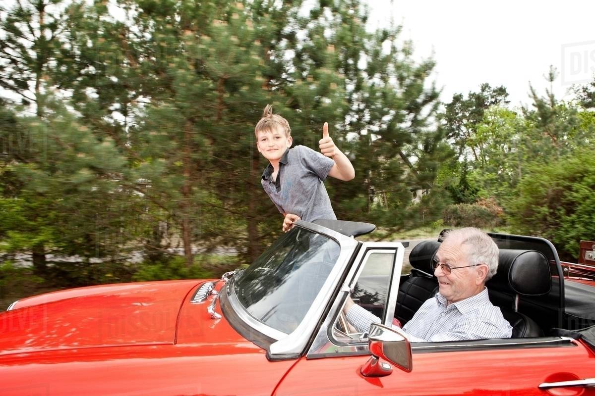 Grandfather and grandson driving in vintage car - Royalty-free Stock ...