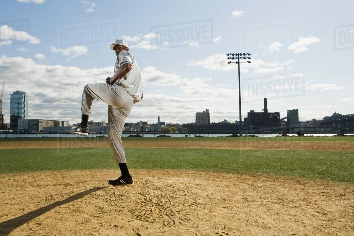 Baseball pitcher standing on one leg - Royalty-free Stock Photo | Dissolve