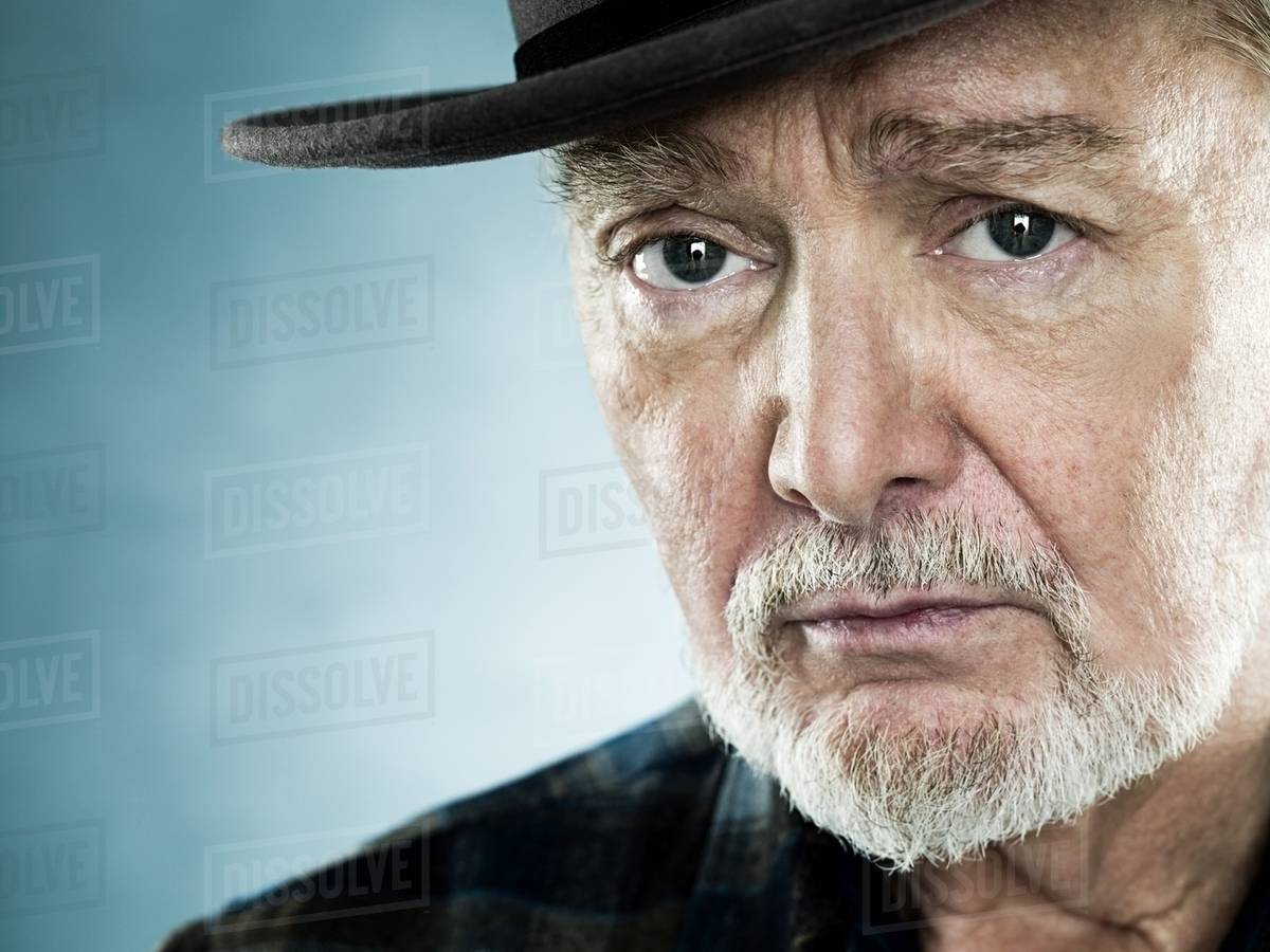 Portrait of a senior man frowning - Stock Photo - Dissolve