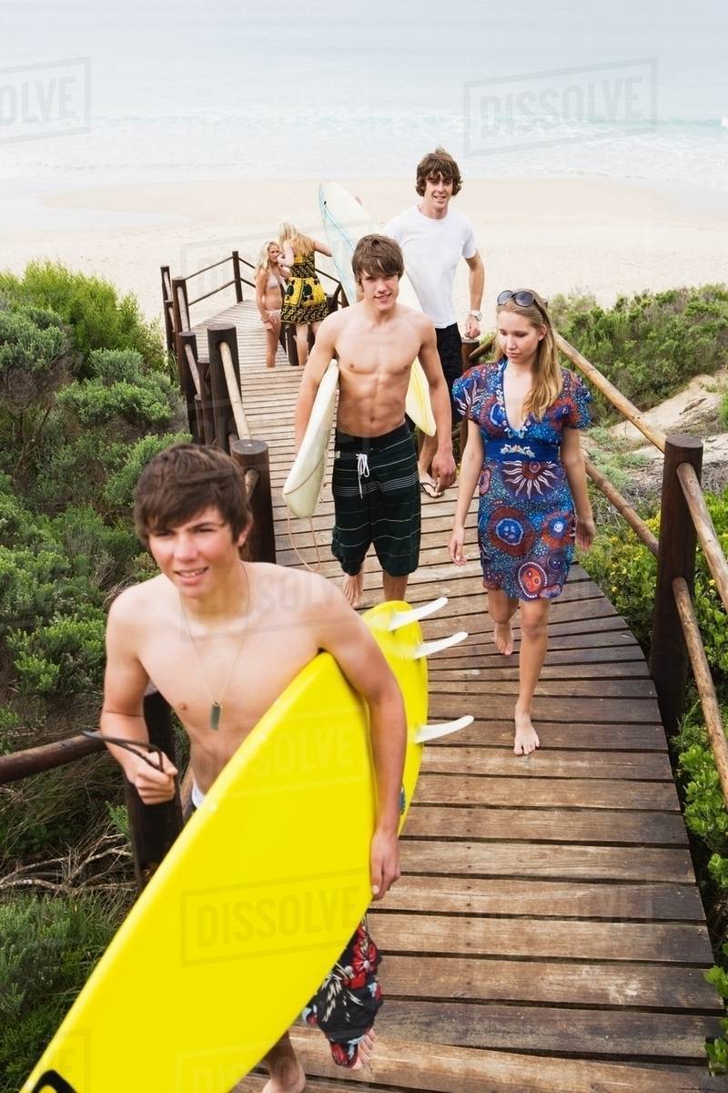 Surfer friends at the coast - Royalty-free Stock Photo | Dissolve