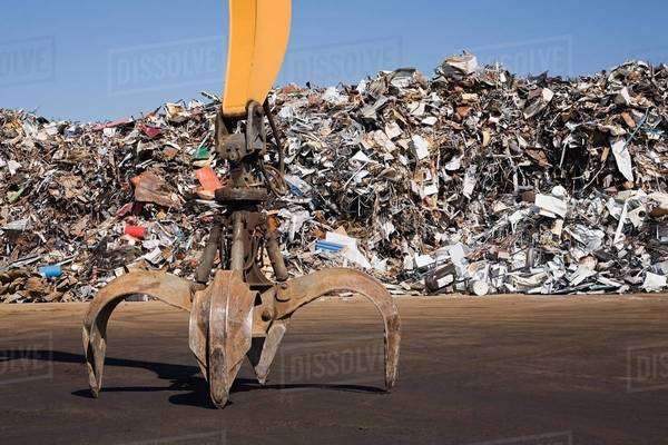Mechanical grabber and waste - Stock Photo - Dissolve