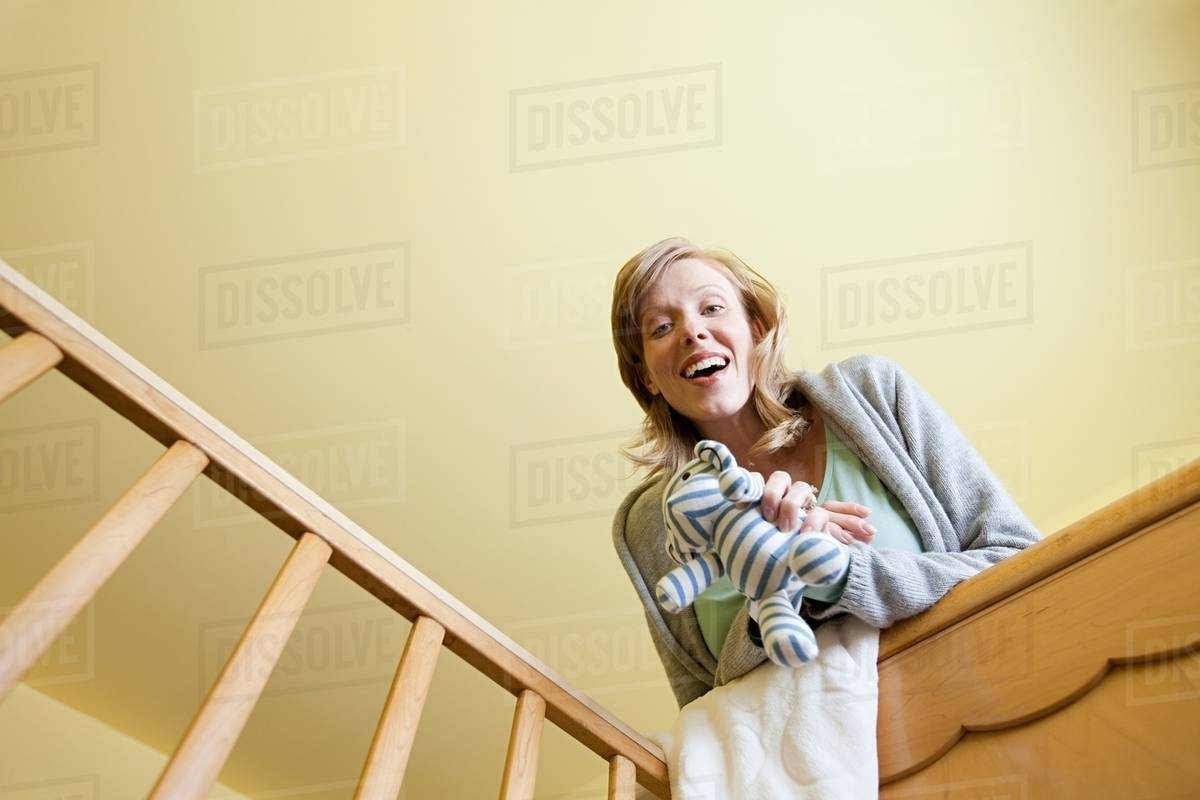 Woman looking in to crib - Royalty-free Stock Photo | Dissolve