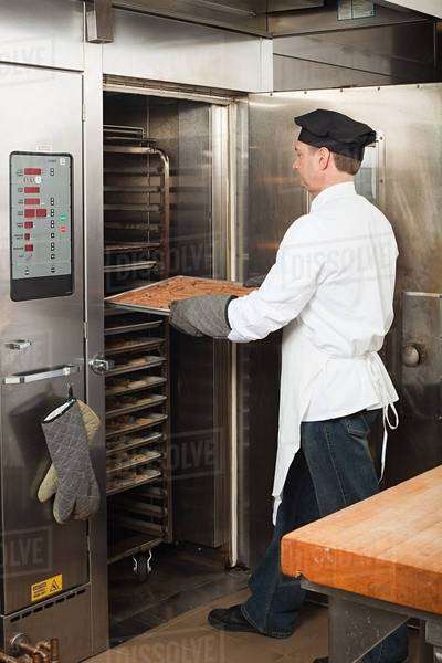 Male chef baking cookies in commercial kitchen - Royalty-free Stock ...