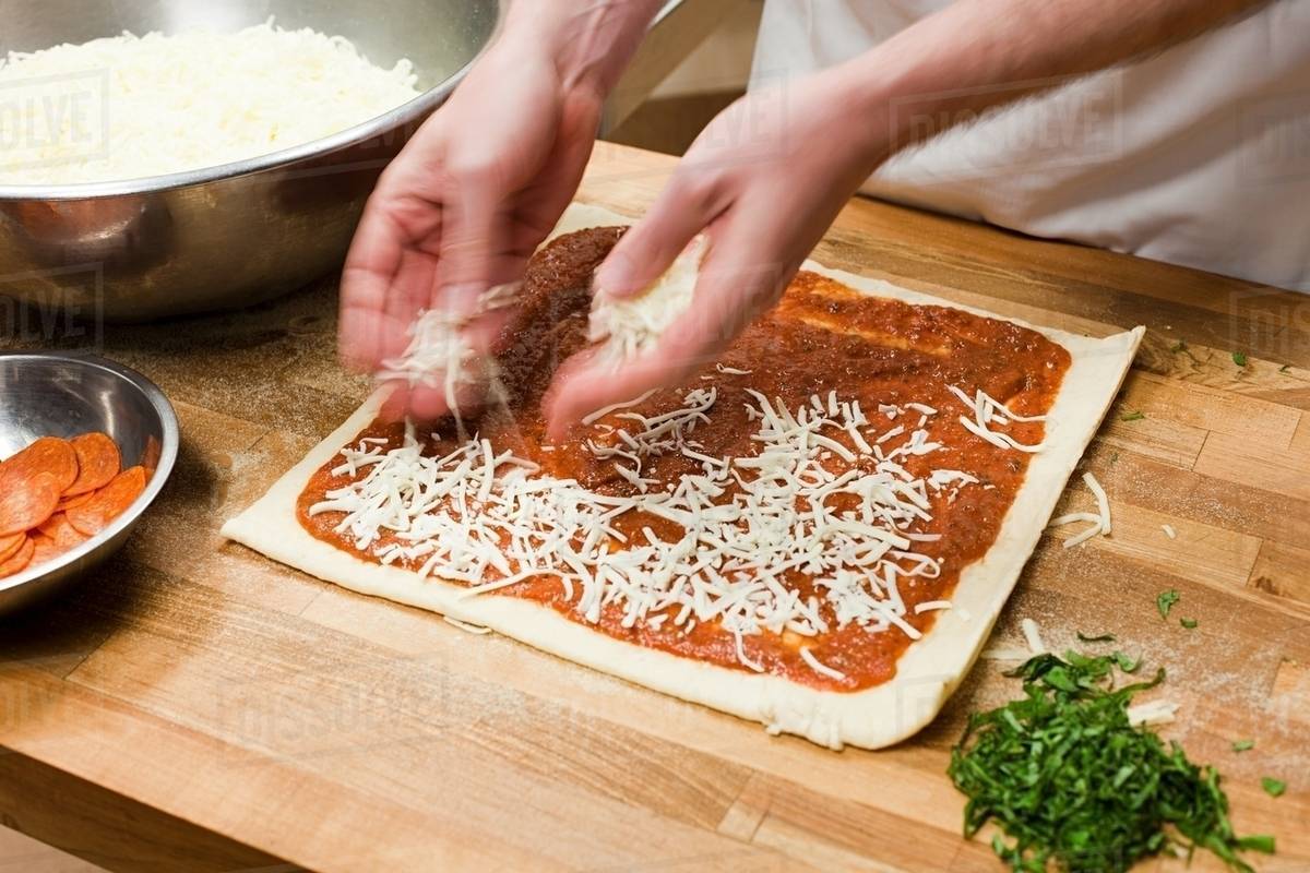 Male chef making pizza in commercial kitchen - Stock Photo - Dissolve