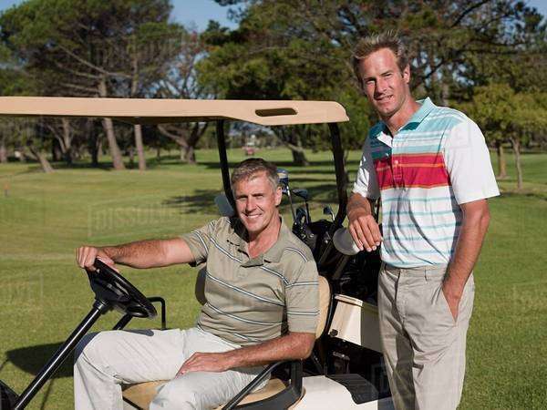 Two mature men in golf cart on golf course - Royalty-free Stock Photo ...