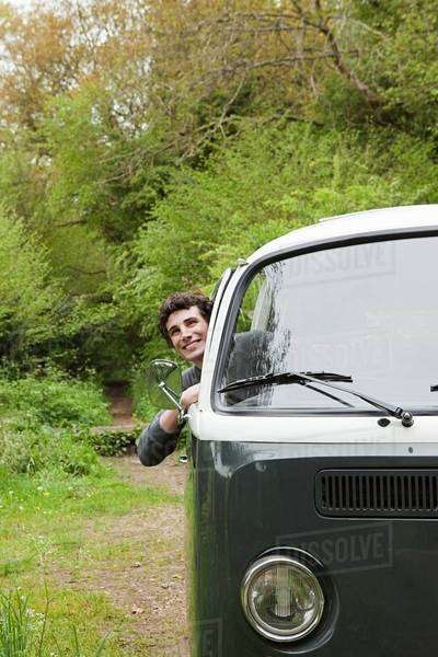 Young man in camper van - Stock Photo - Dissolve