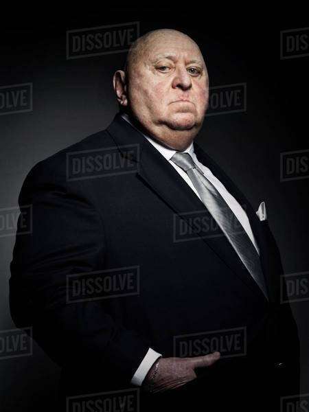Studio portrait of serious gangster - Royalty-free Stock Photo | Dissolve