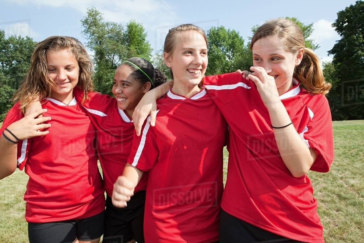 Girl soccer players laughing - Stock Photo - Dissolve