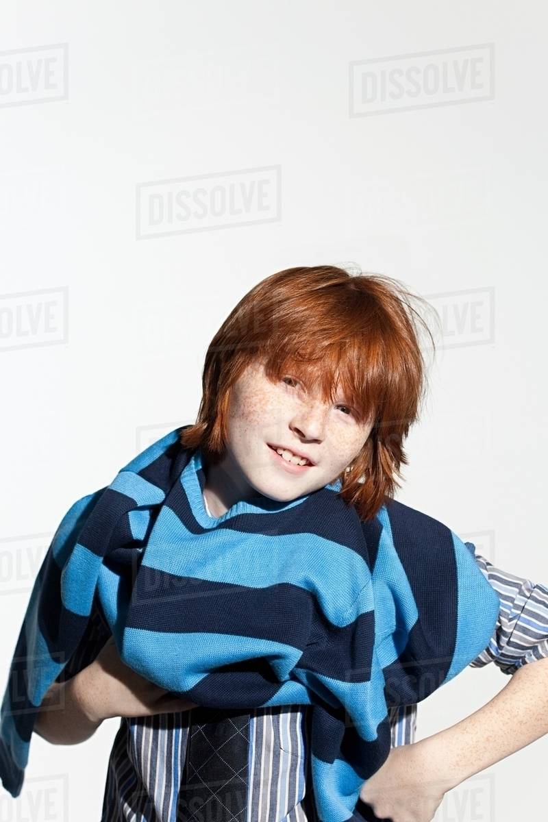 Boy taking off his sweater - Stock Photo - Dissolve