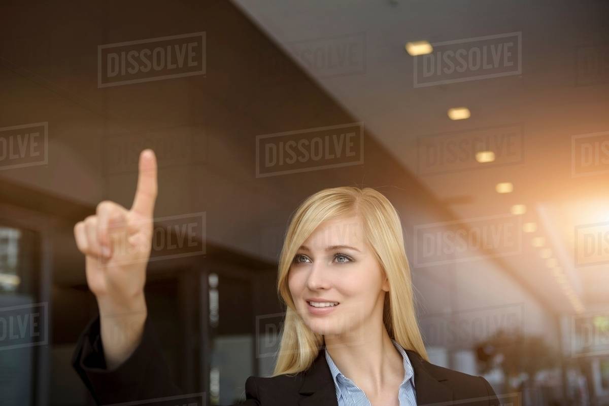 Young businesswoman signaling with finger in office - Stock Photo ...
