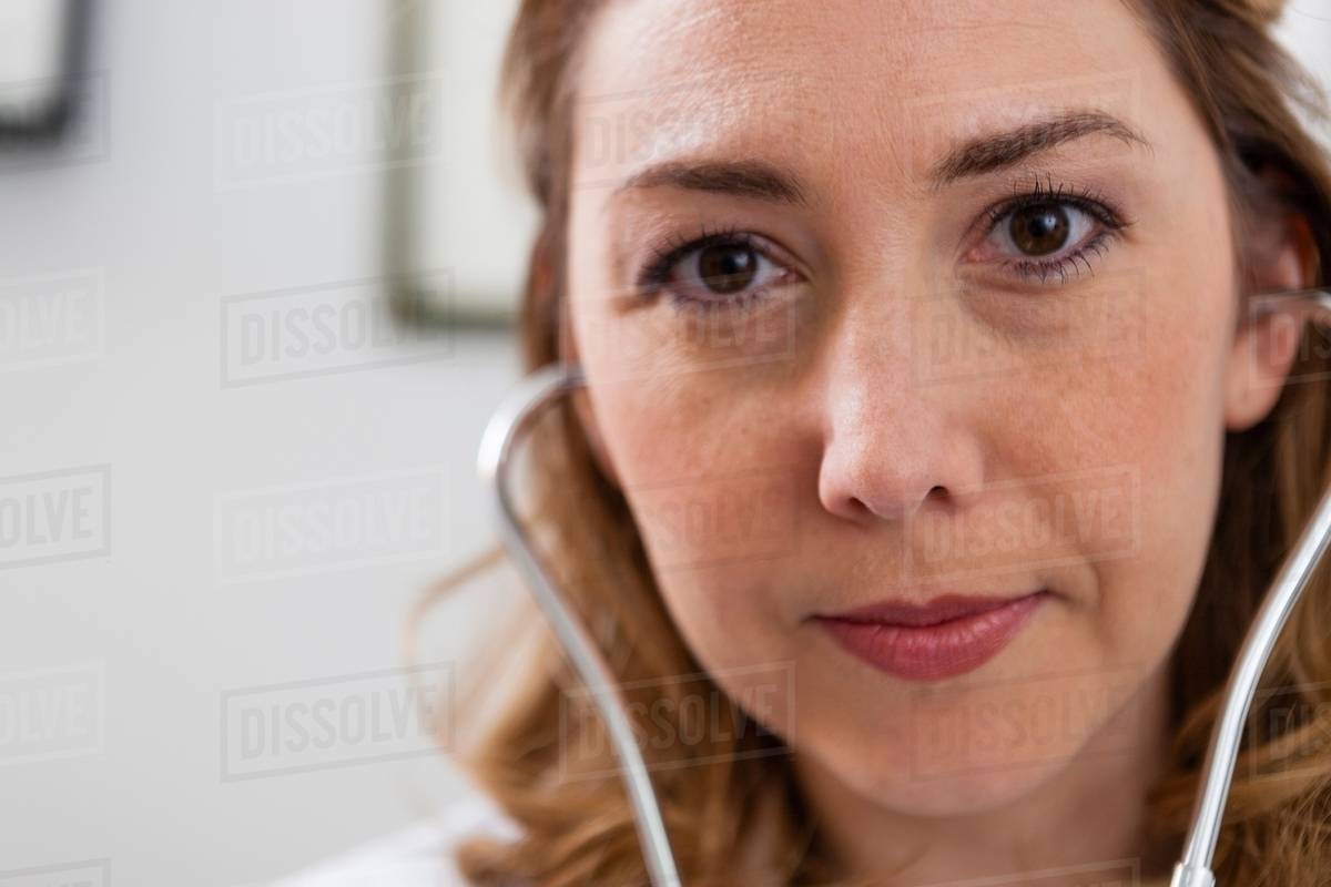 Mid adult doctor wearing stethoscope, portrait - Royalty-free Stock ...