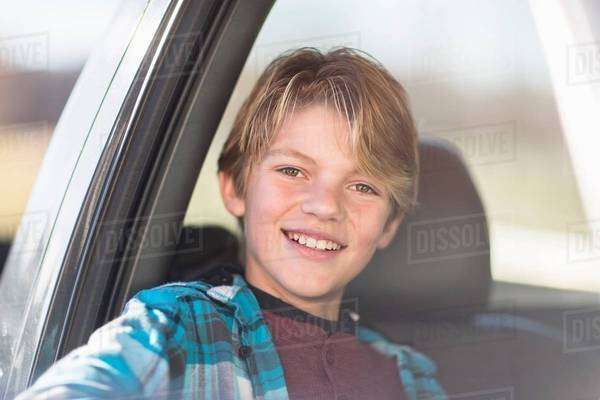 Boy smiling in car - Royalty-free Stock Photo | Dissolve