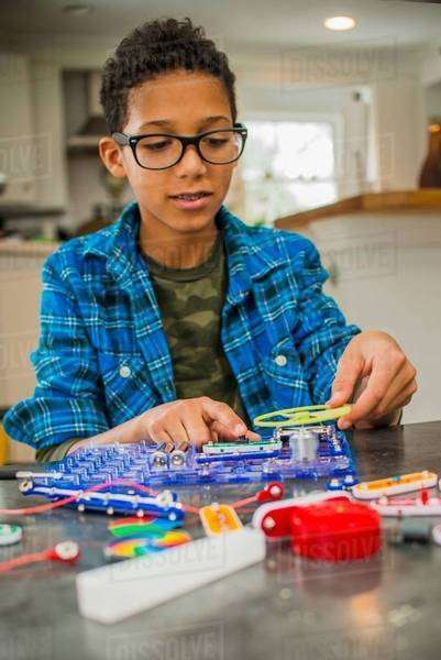Boy working on science project at home - Royalty-free Stock Photo ...