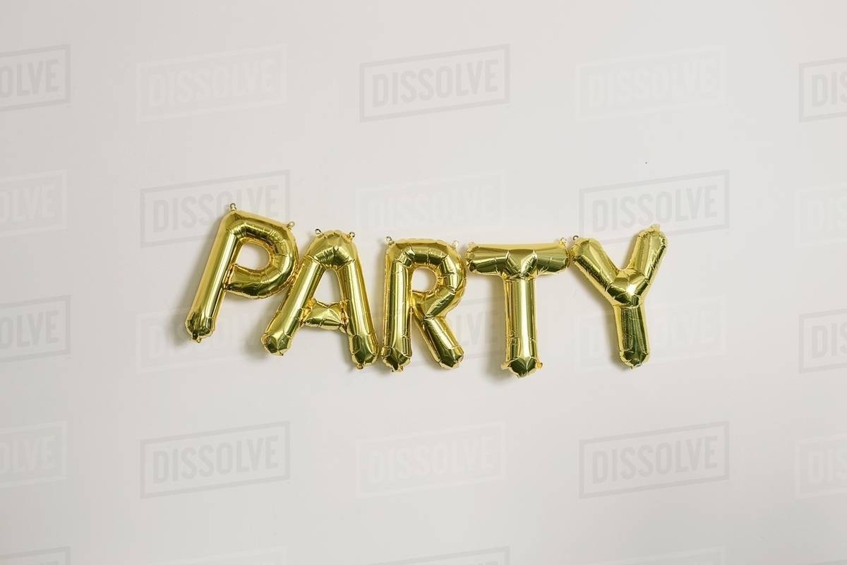 Word party in gold inflatable capital letters - Stock Photo - Dissolve