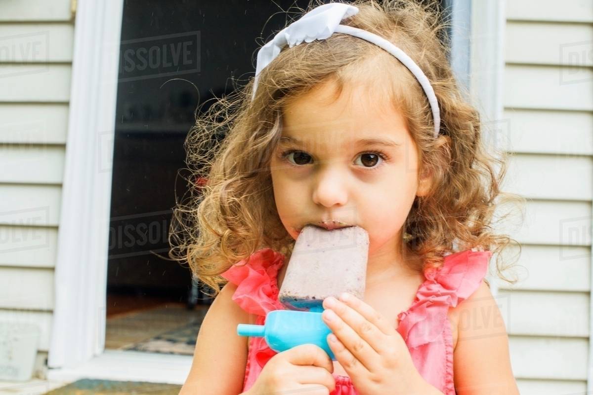 Portrait of young girl, eating ice lolly - Royalty-free Stock Photo ...