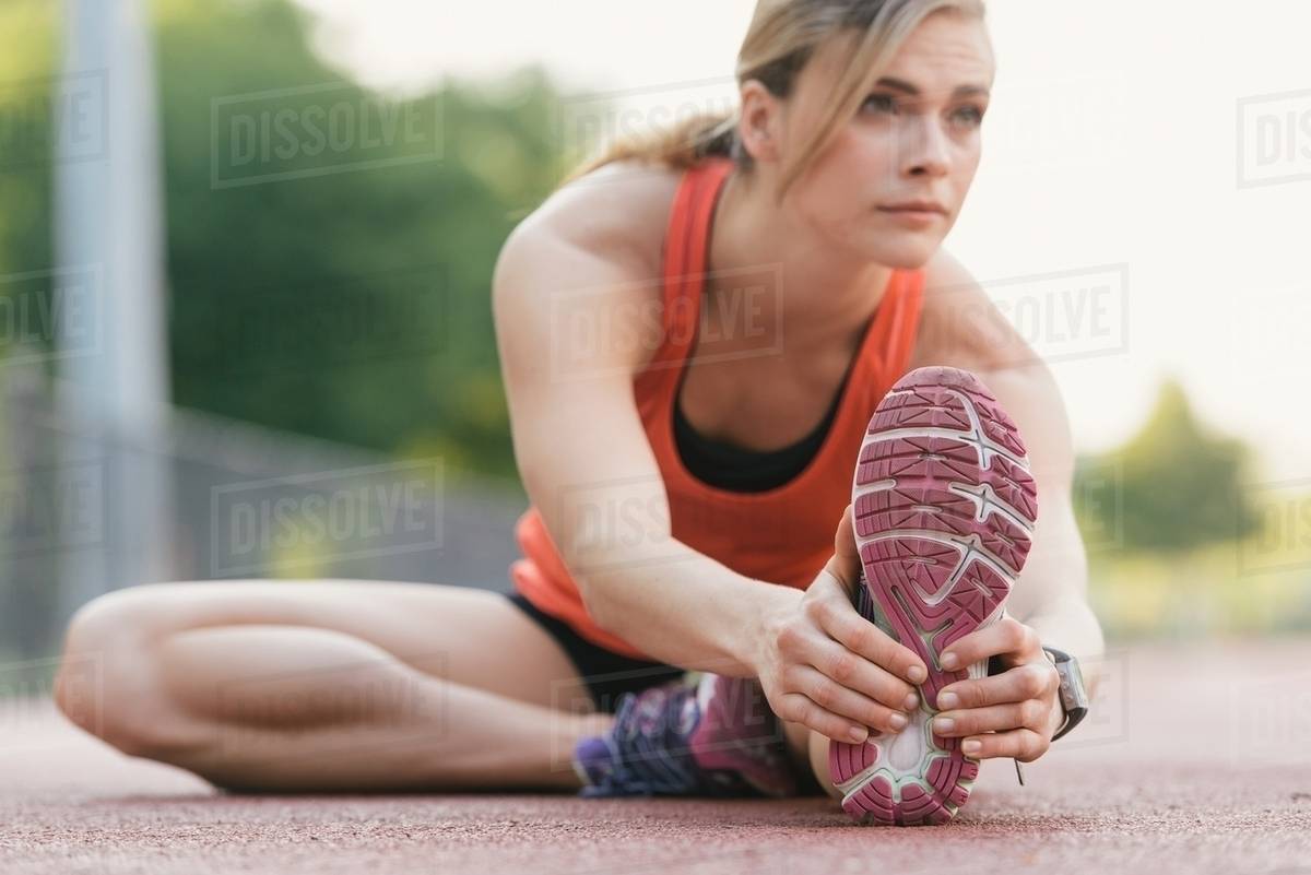 Young woman working out, stretching, outdoors - Royalty-free Stock ...