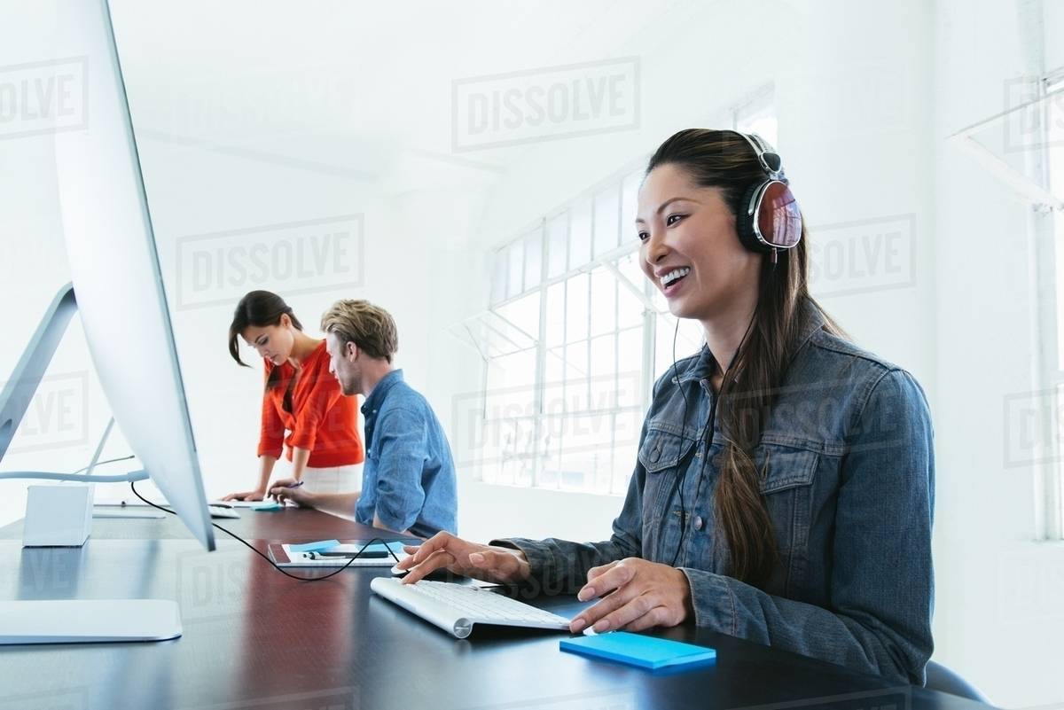 Business people working on computer by office window - Stock Photo ...